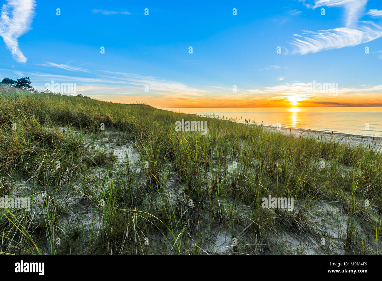Sandy beach and sunset sky with golden sun shining on white sand Stock ...