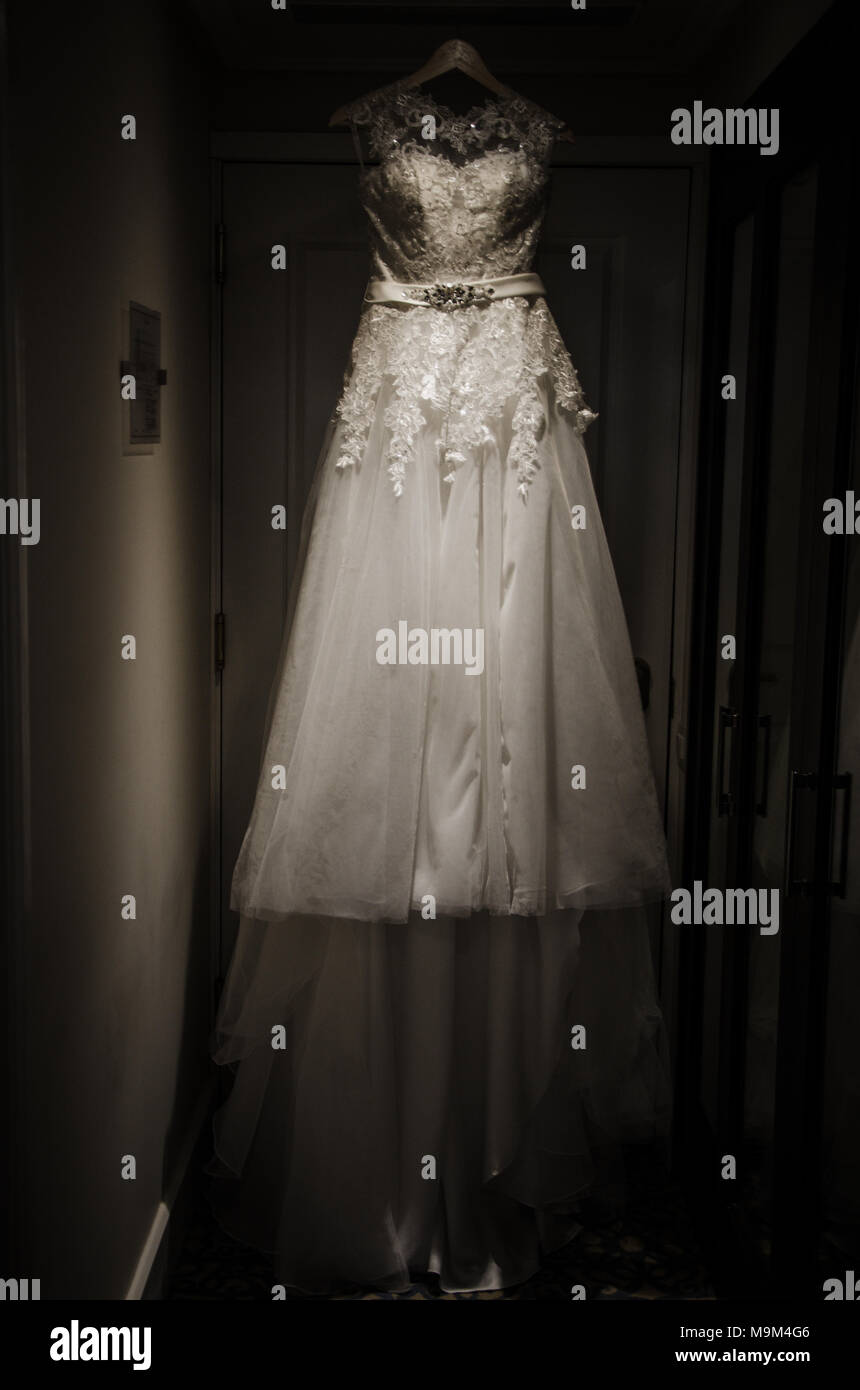 Wedding dress hanging on a coat rack Stock Photo - Alamy
