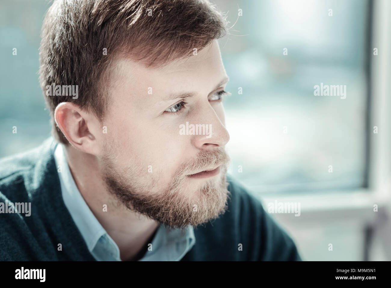 Deep calm man looking aside and thinking Stock Photo - Alamy