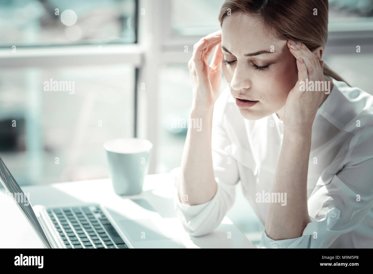 Exhausted loaded woman sitting and feeling bad herself Stock Photo - Alamy