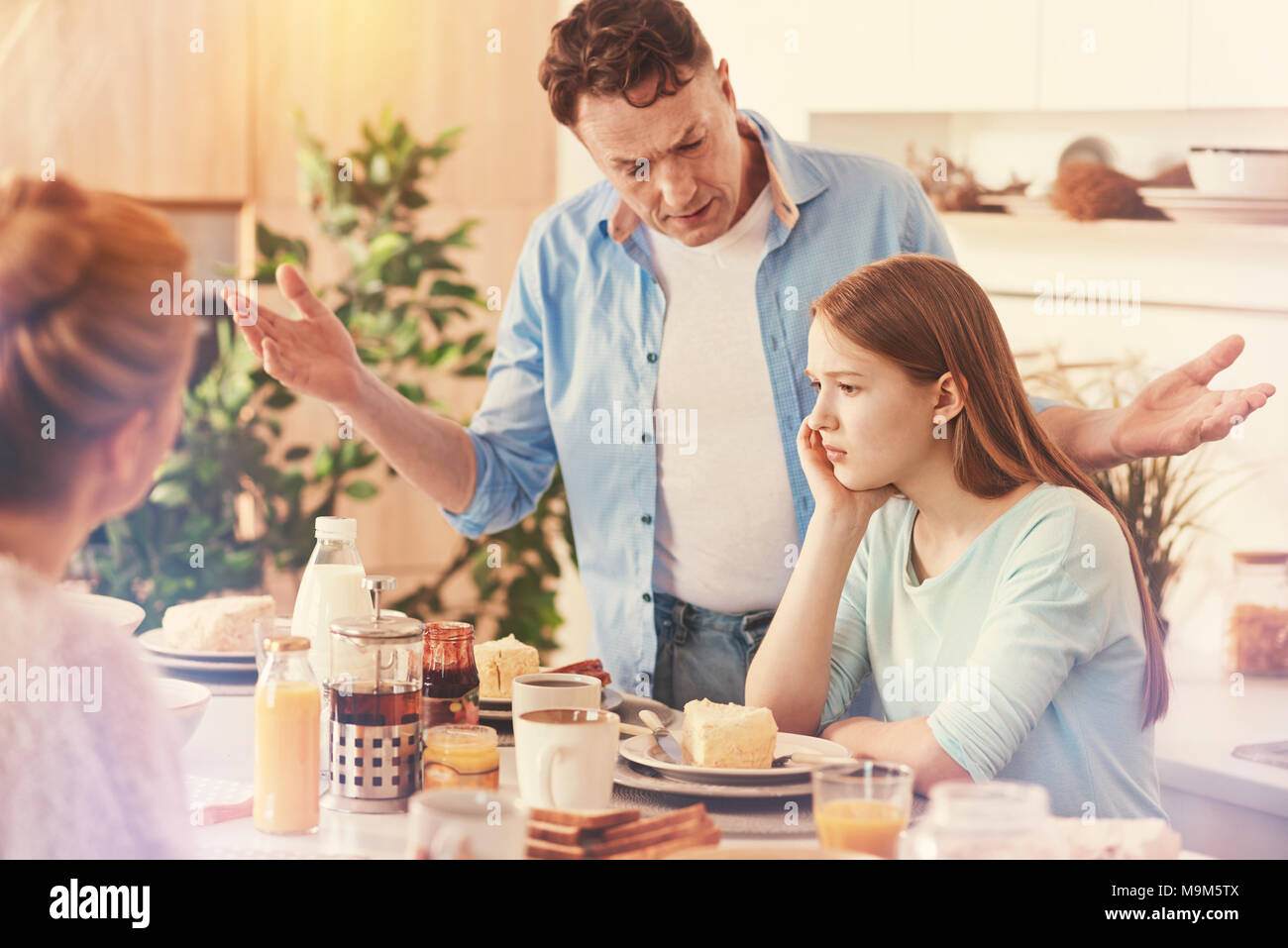 Angry dad raising his arms while talking with daughter Stock Photo - Alamy