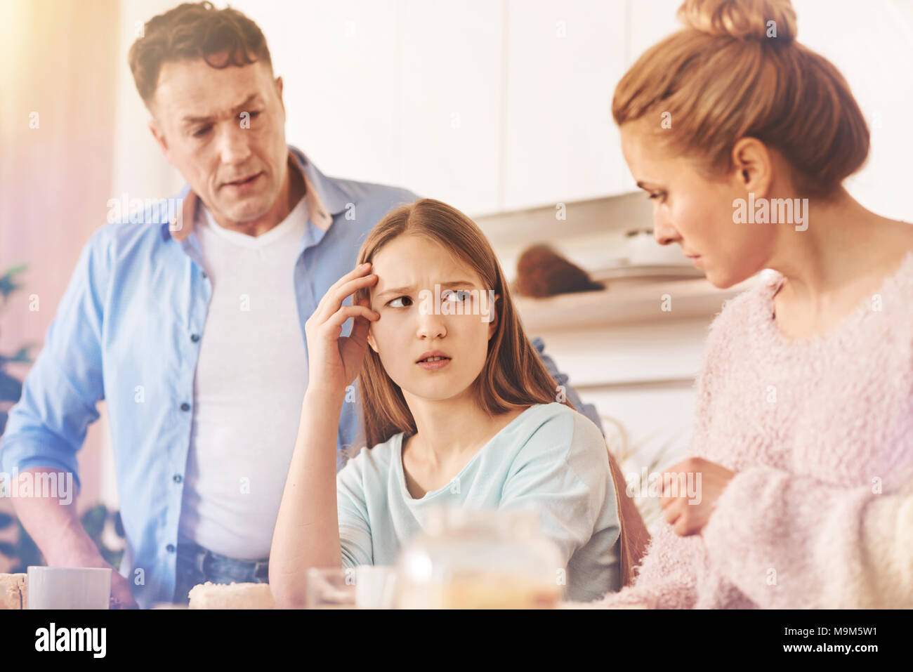 Scared girl looking angrily at her mother Stock Photo - Alamy