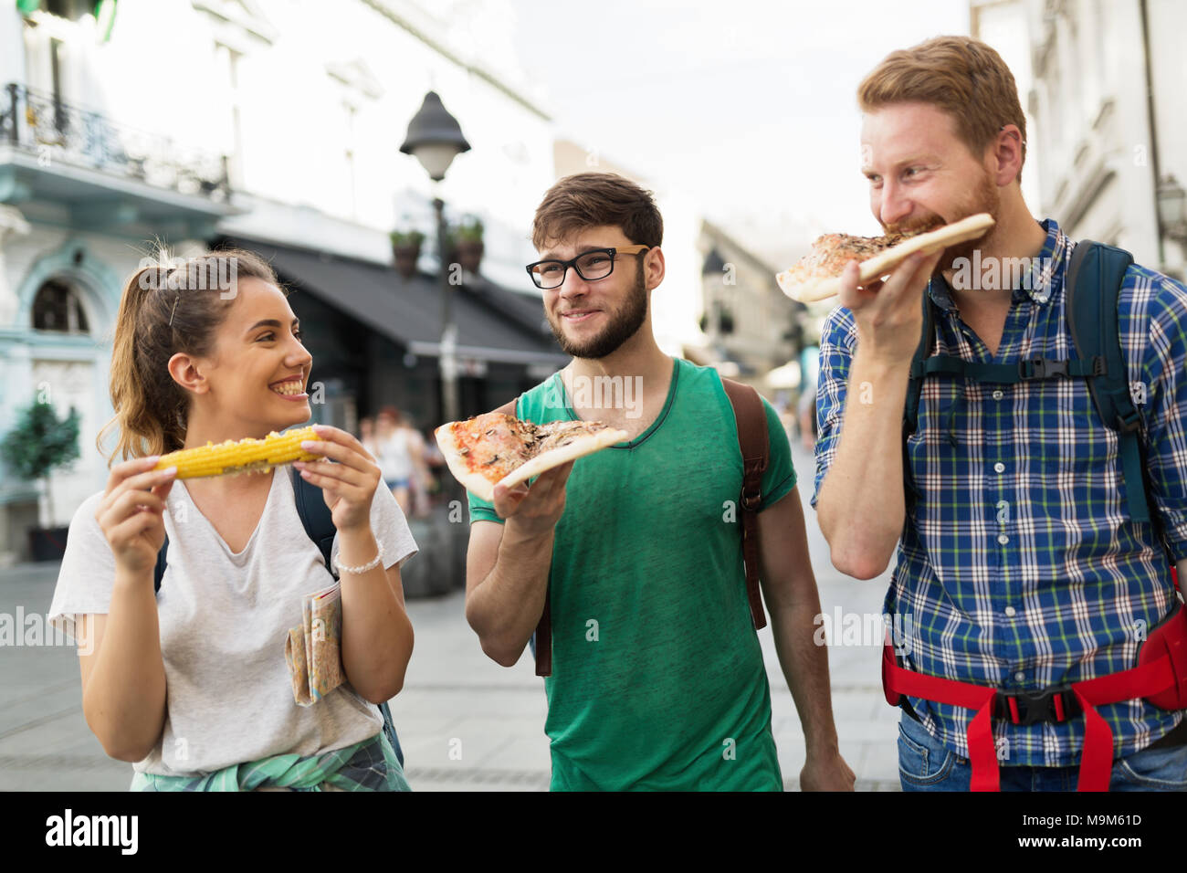 Happy people eating fast food in city Stock Photo - Alamy