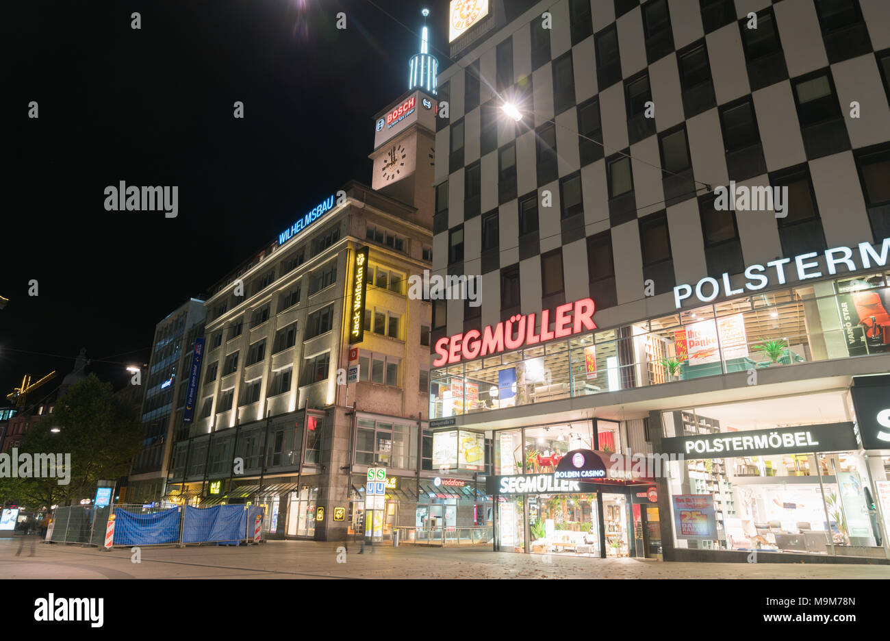 Stuttgart night street with large retail brands noen signage and ...