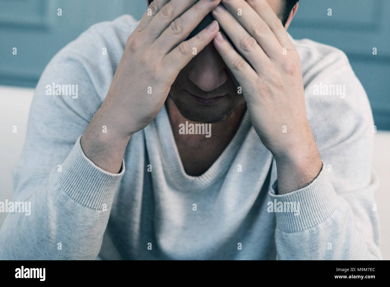 Upset male person covering his face Stock Photo - Alamy