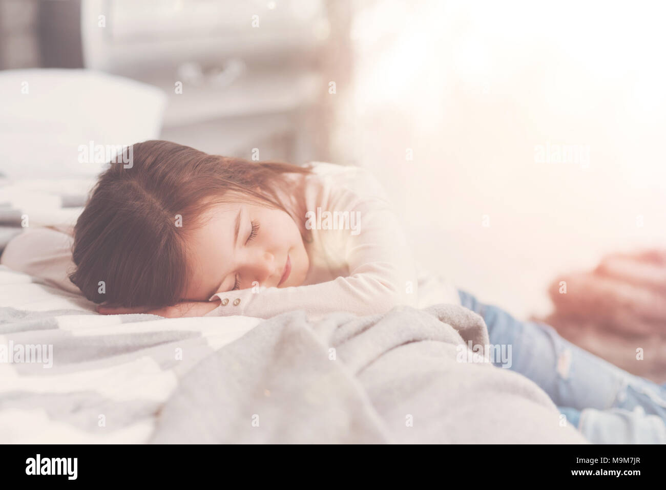 Enchanting young child taking some rest Stock Photo - Alamy