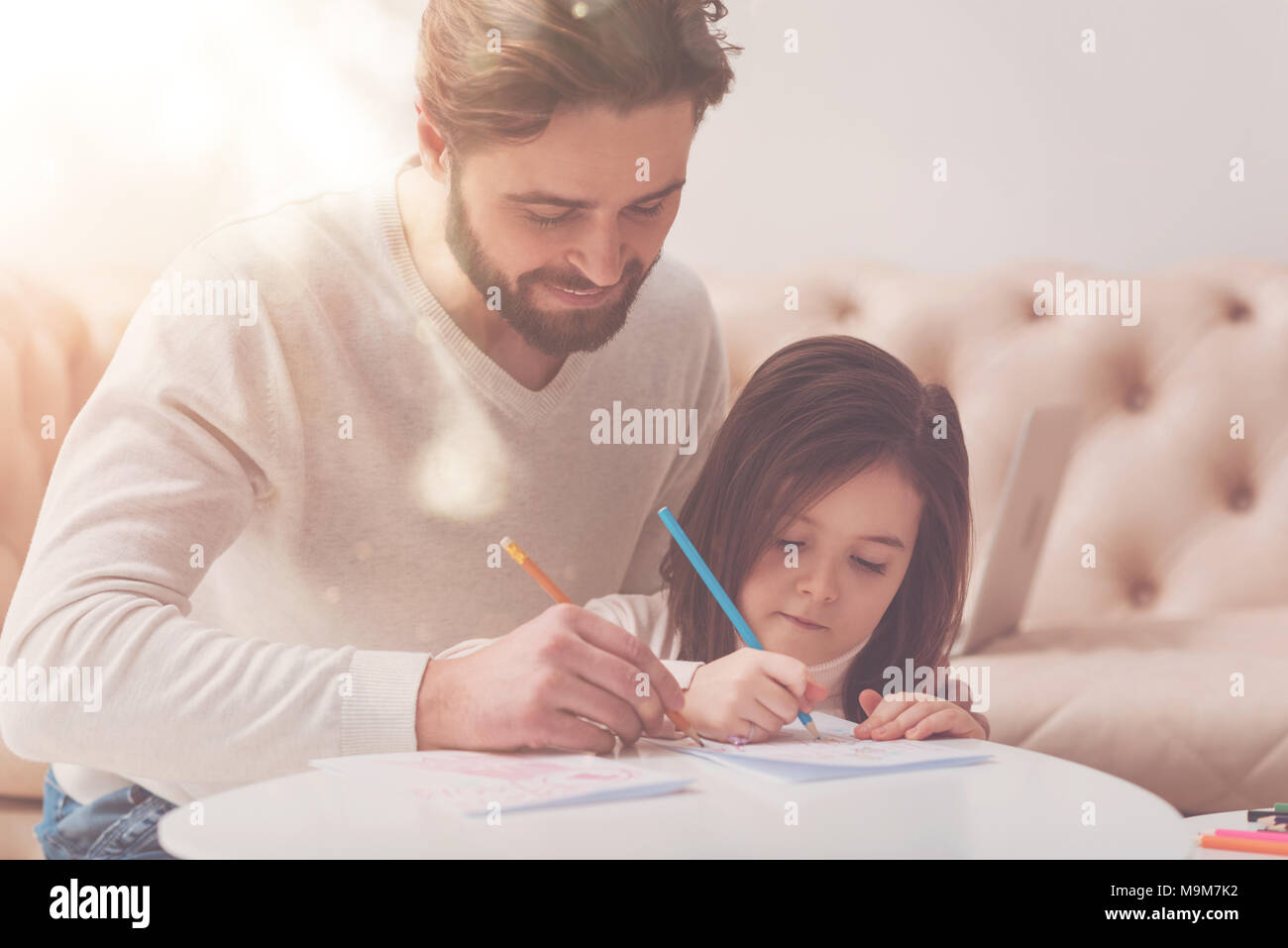 Supportive enthusiastic father helping his child Stock Photo - Alamy