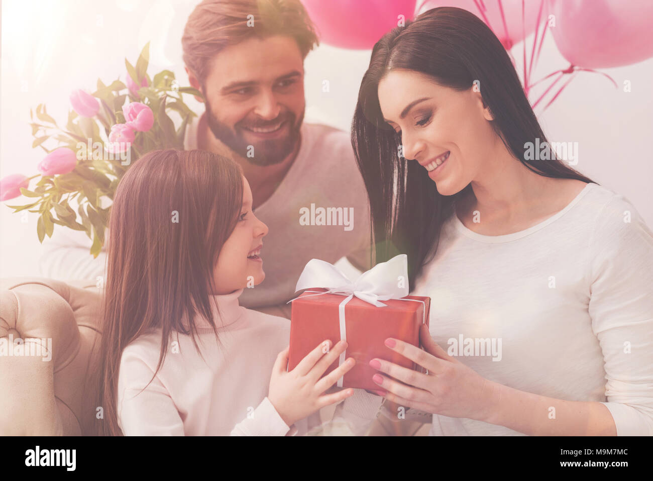 Excited gorgeous lady receiving a present Stock Photo - Alamy