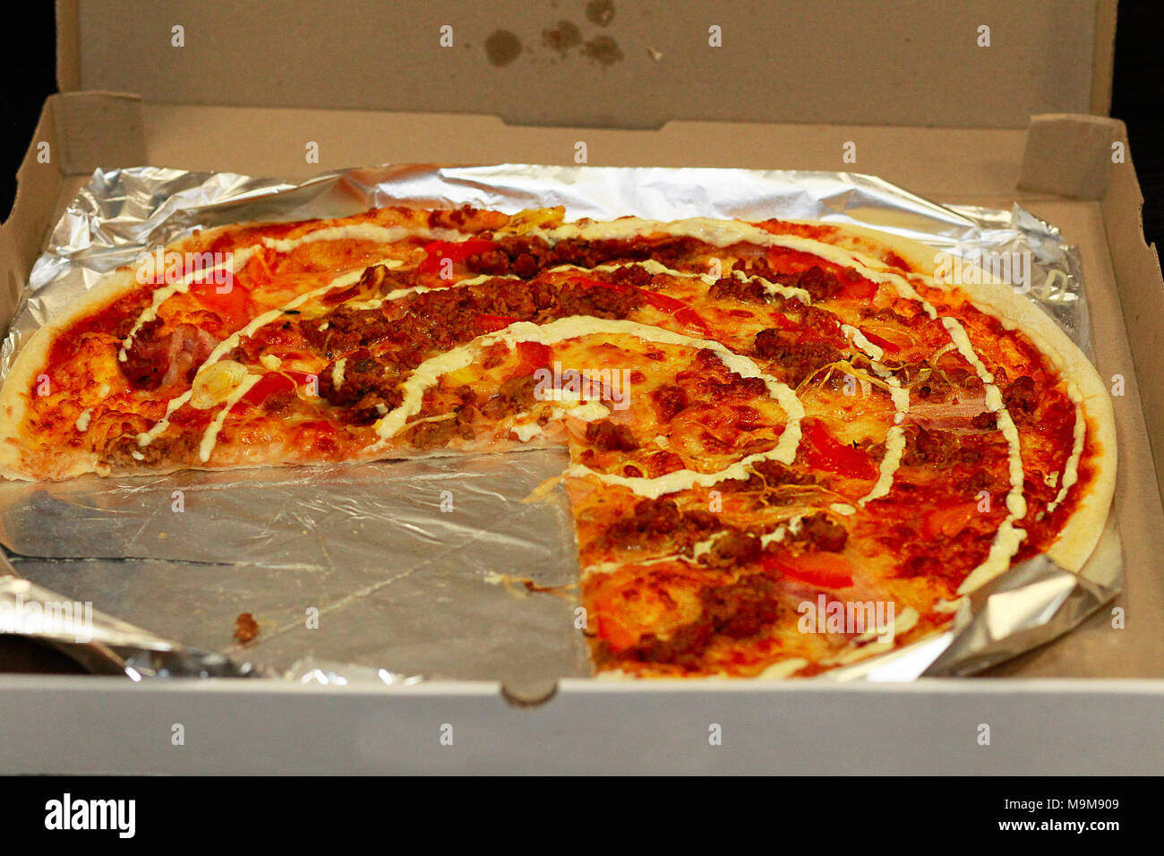 Pizza in a box with a broken piece. Pizza from the cafe. Pizza. The ...