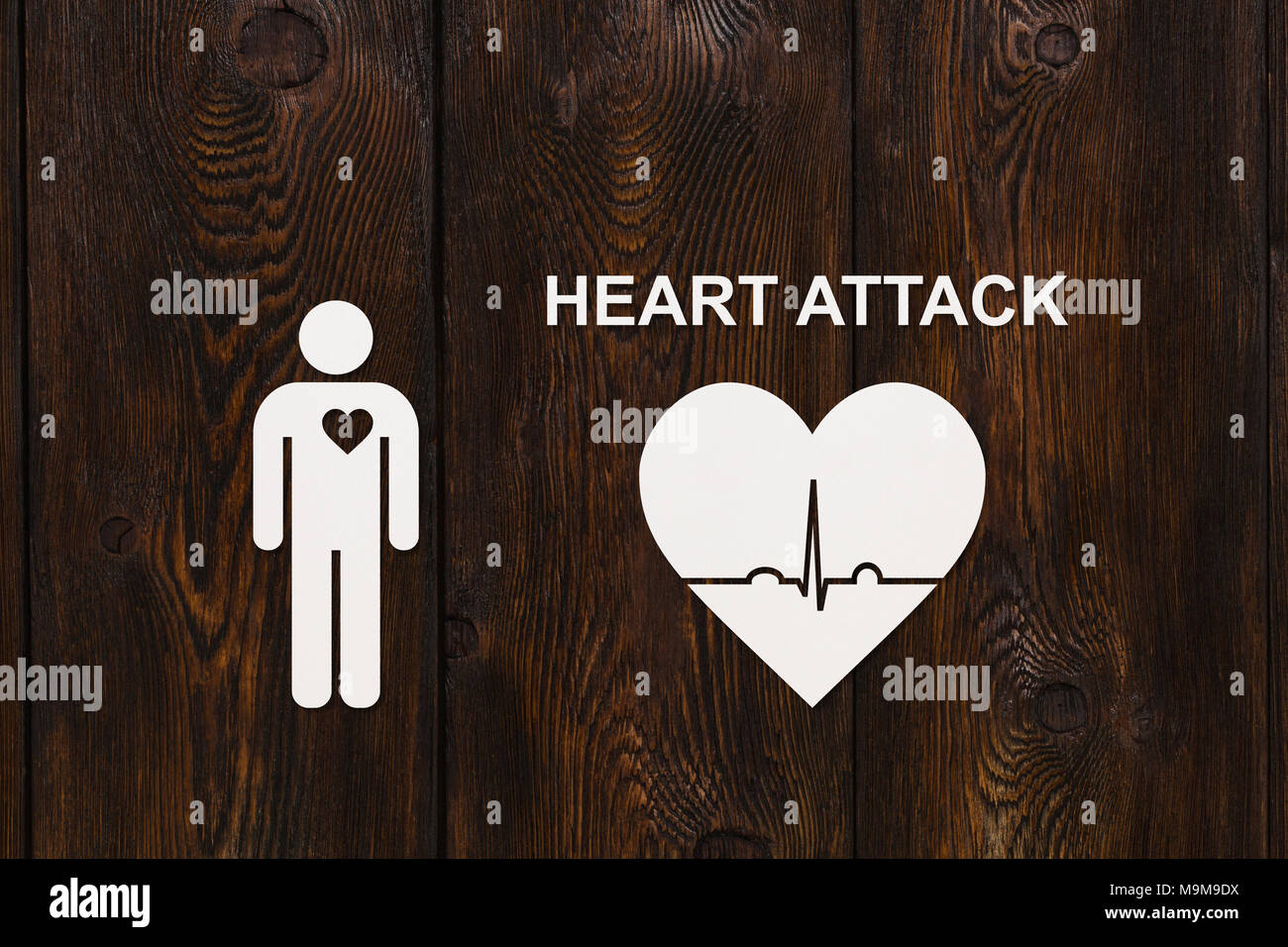 Paper man with echocardiogram and HEART ATTACK text. Medical cardiology ...