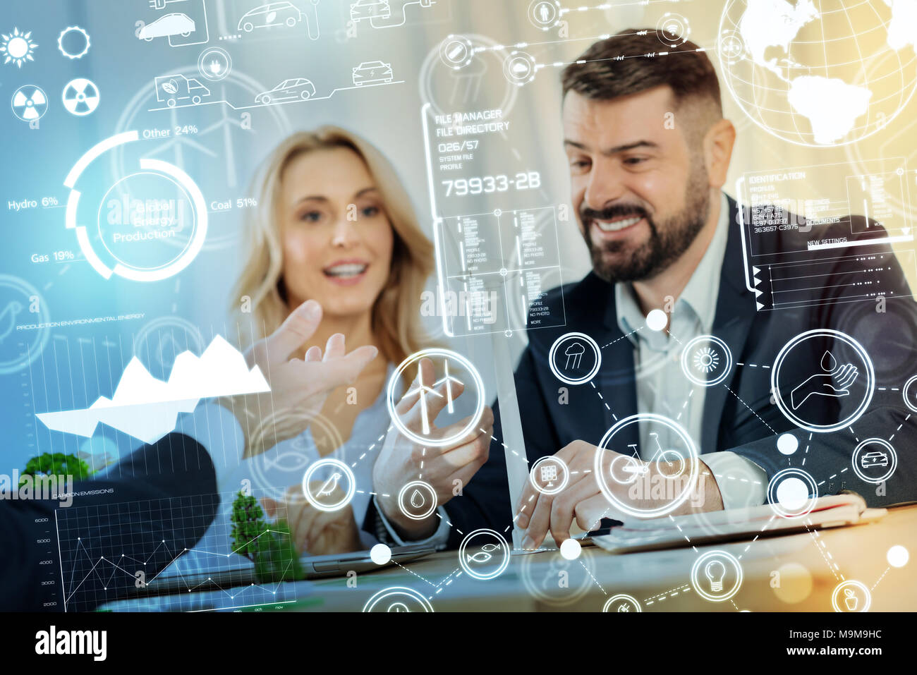 Emotional eco engineers looking at the windmill turbines and talking ...