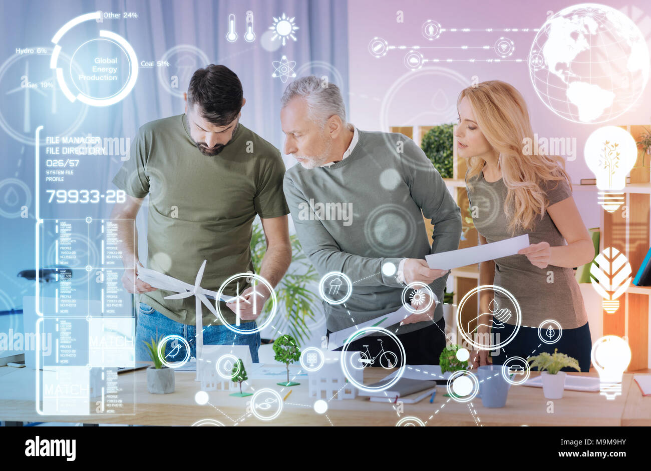 Serious engineers looking busy while working with schemes Stock Photo ...