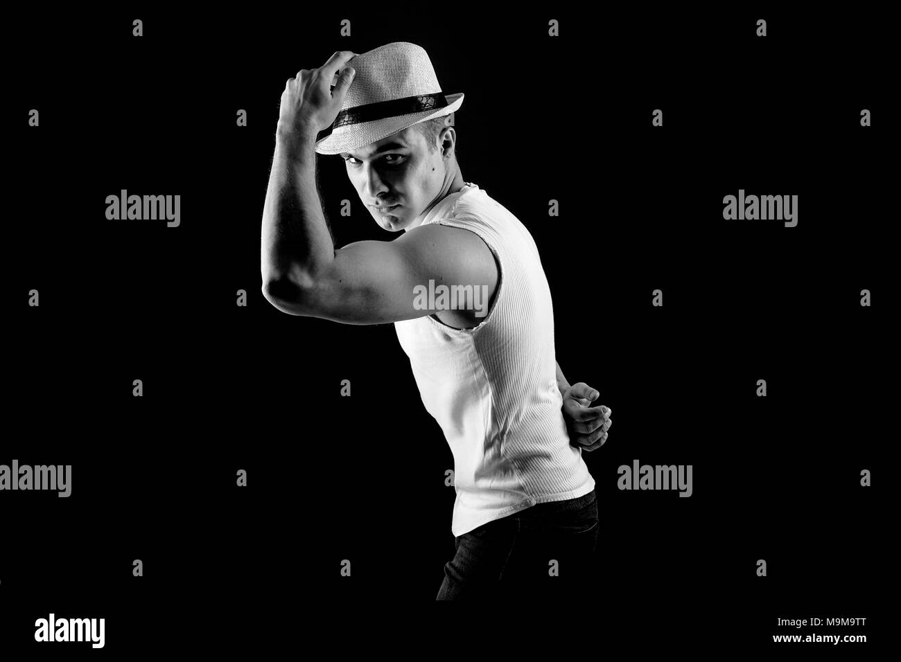 Man fashion model, stylish young man wearing fedora hat standing posing ...