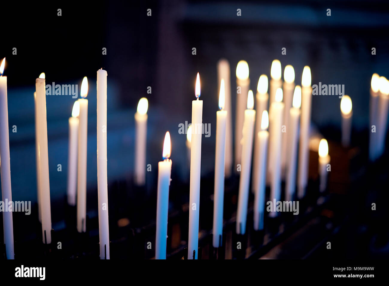 Lit candles in a church Stock Photo - Alamy