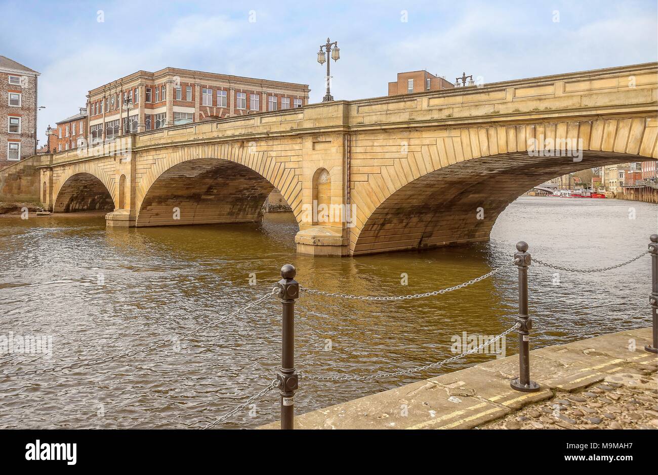 Stone built 19th Ouse Bridge in York spans the river. City buildings ...