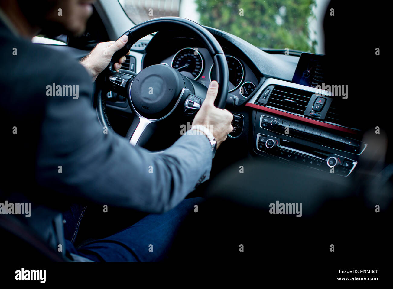 Back view of an handsome smiling business man driving his car Stock ...
