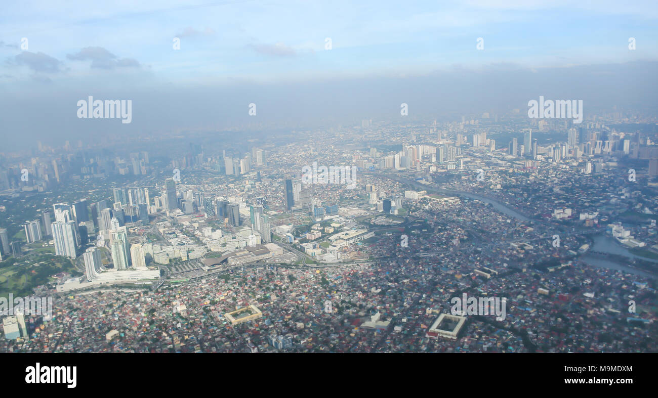 A view of the city of Manila through the window from the plane ...