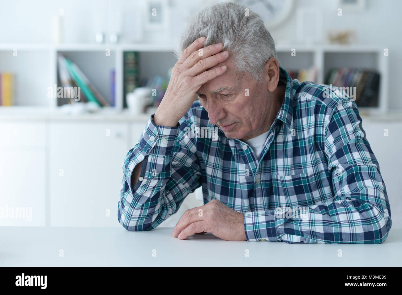 Portrait of Sad senior man at home Stock Photo - Alamy