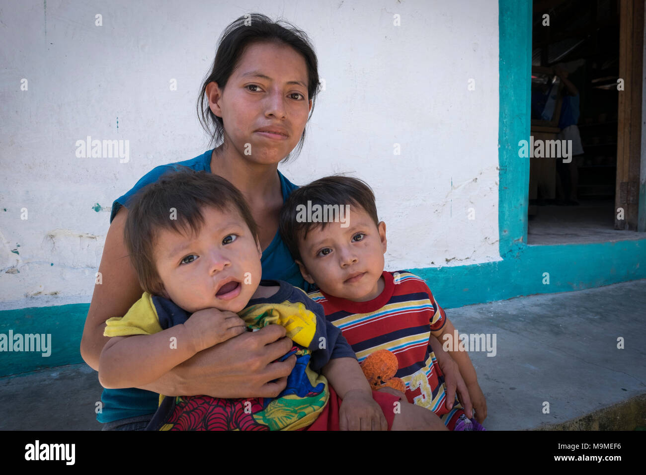 A young mother with her two infant children in the rural Guatemalan ...