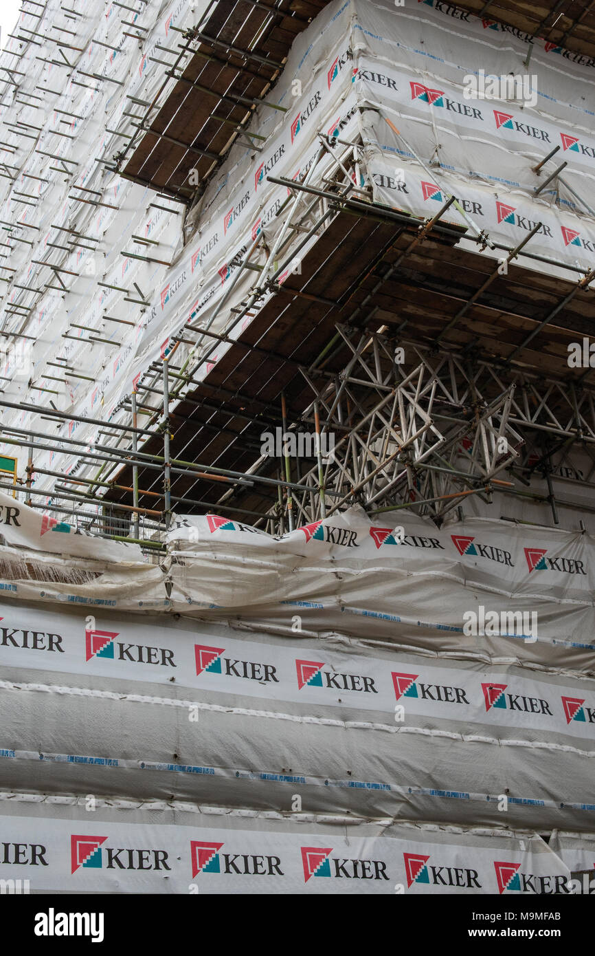 scaffold wrapped in a protective covering or sheathing to prevent dust ...
