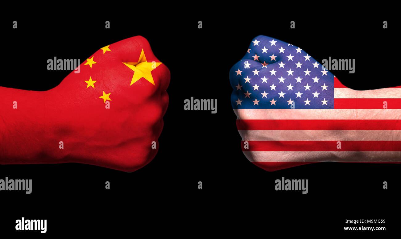 Flags Of Usa And China On Two Clenched Fists Facing Each Other On Black