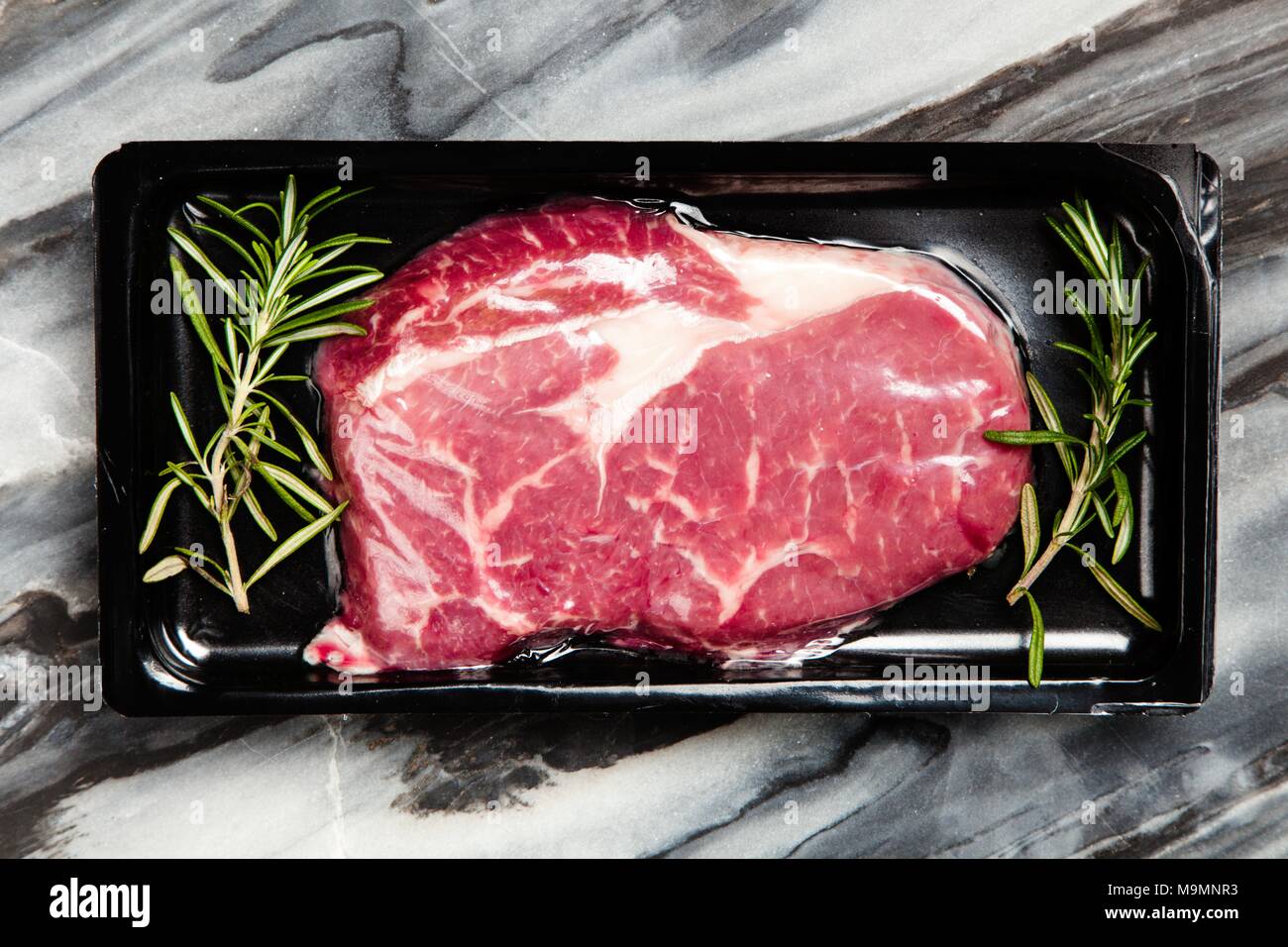 Raw steak in an airtight packaging Stock Photo - Alamy