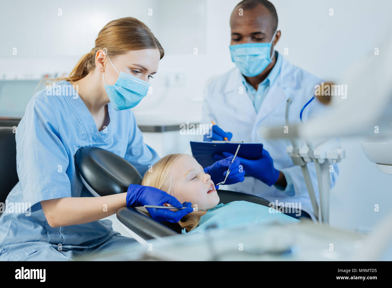 Careful supervision. Pleasant medical student carrying out an ...