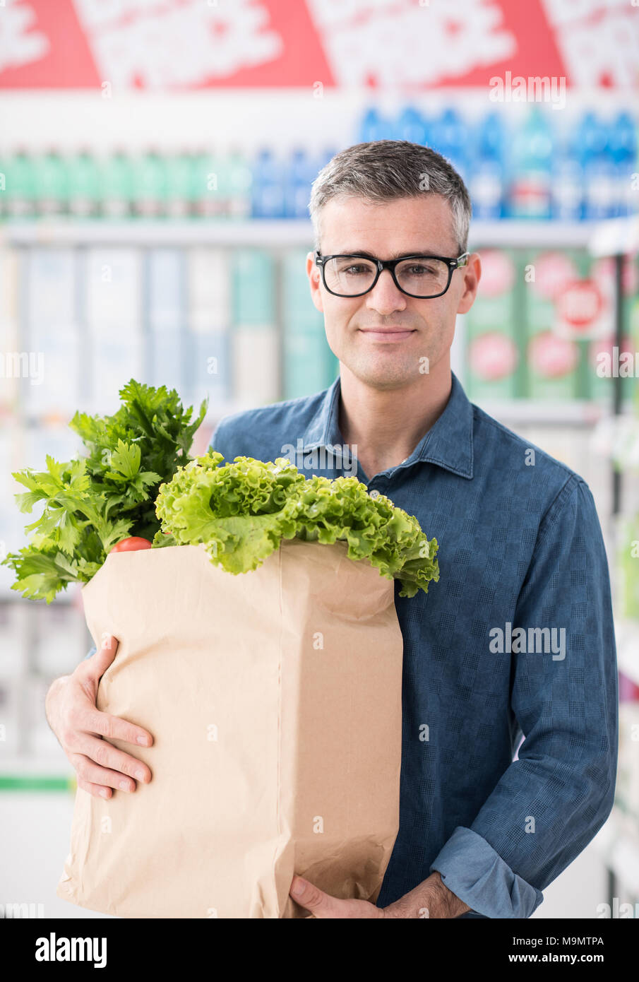 Man carrying supermarket bag hi-res stock photography and images - Alamy