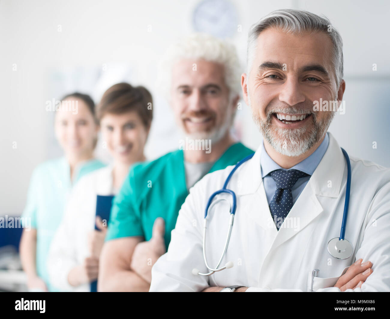Medical team standing in line at the hospital and senior professional ...