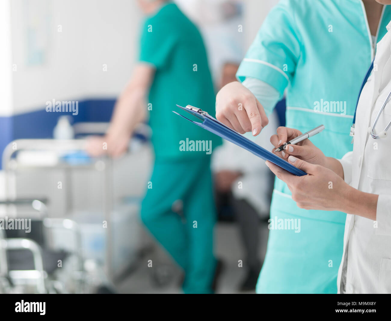 Medical staff working at the hospital: doctor and nurse checking a ...