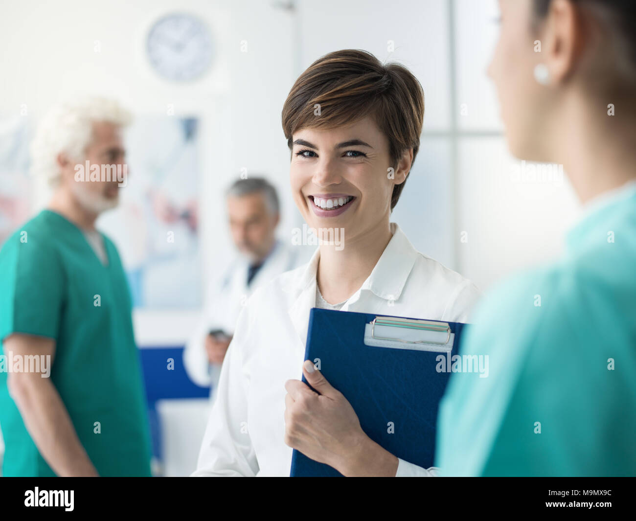 Confident smiling female doctor working at the hospital and medical ...