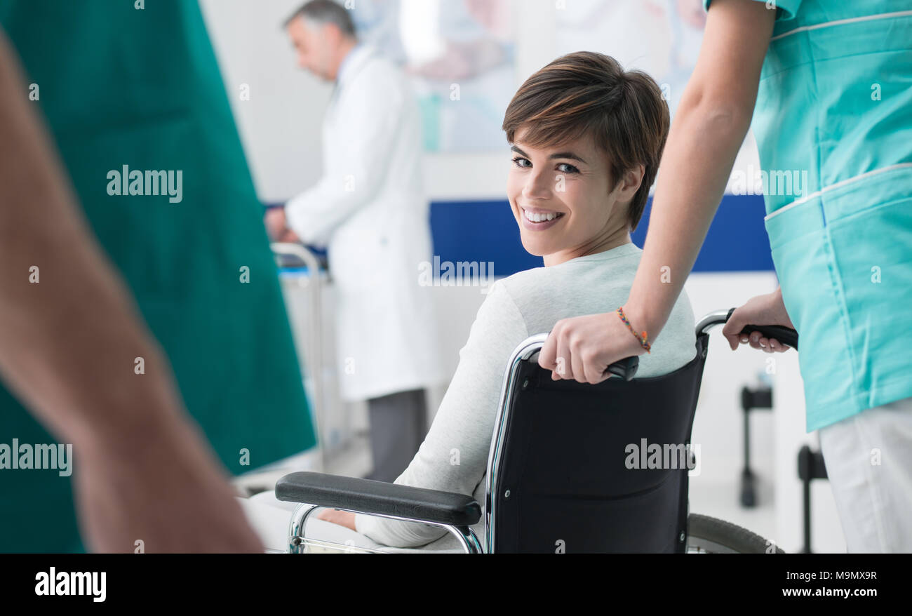 Smiling female disabled patient at the hospital meeting her doctor for ...