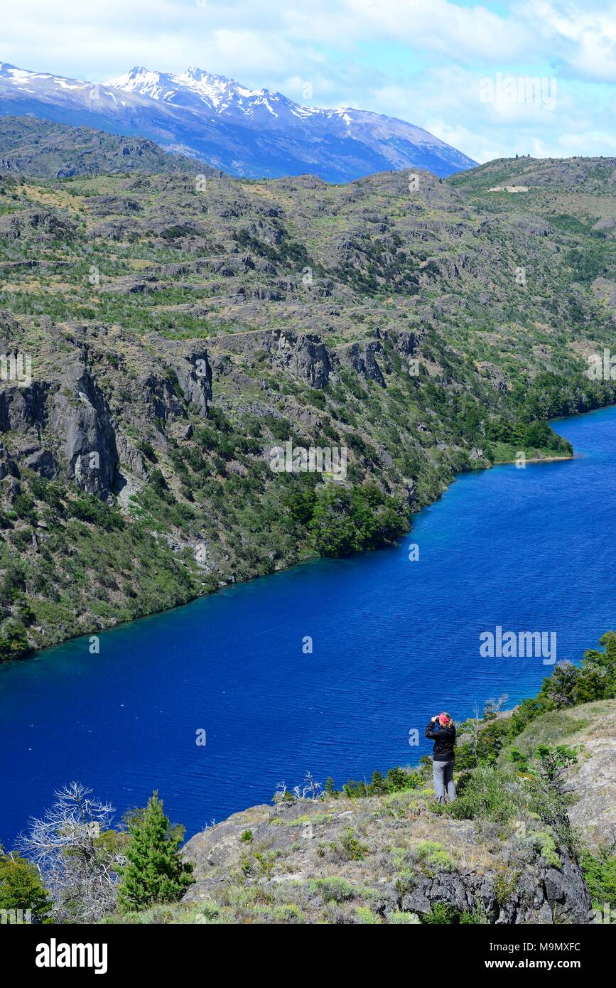 Tourist with binoculars at Lago Cochrane, Reserva Nacional Lago ...