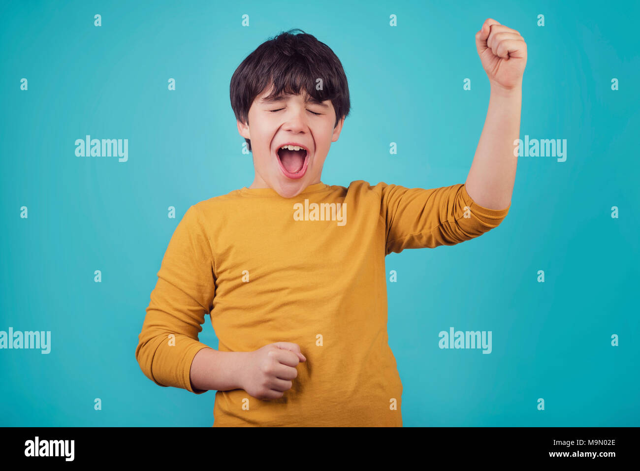 smiling and euphoric boy on blue background smiling and euphoric boy on ...