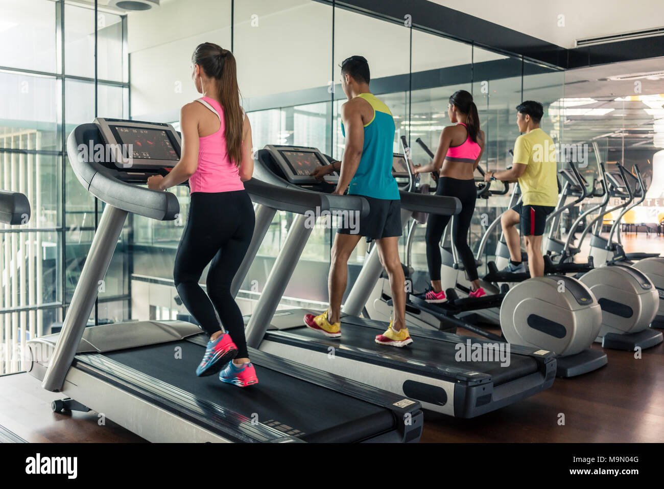Young women running on treadmill hi-res stock photography and images ...