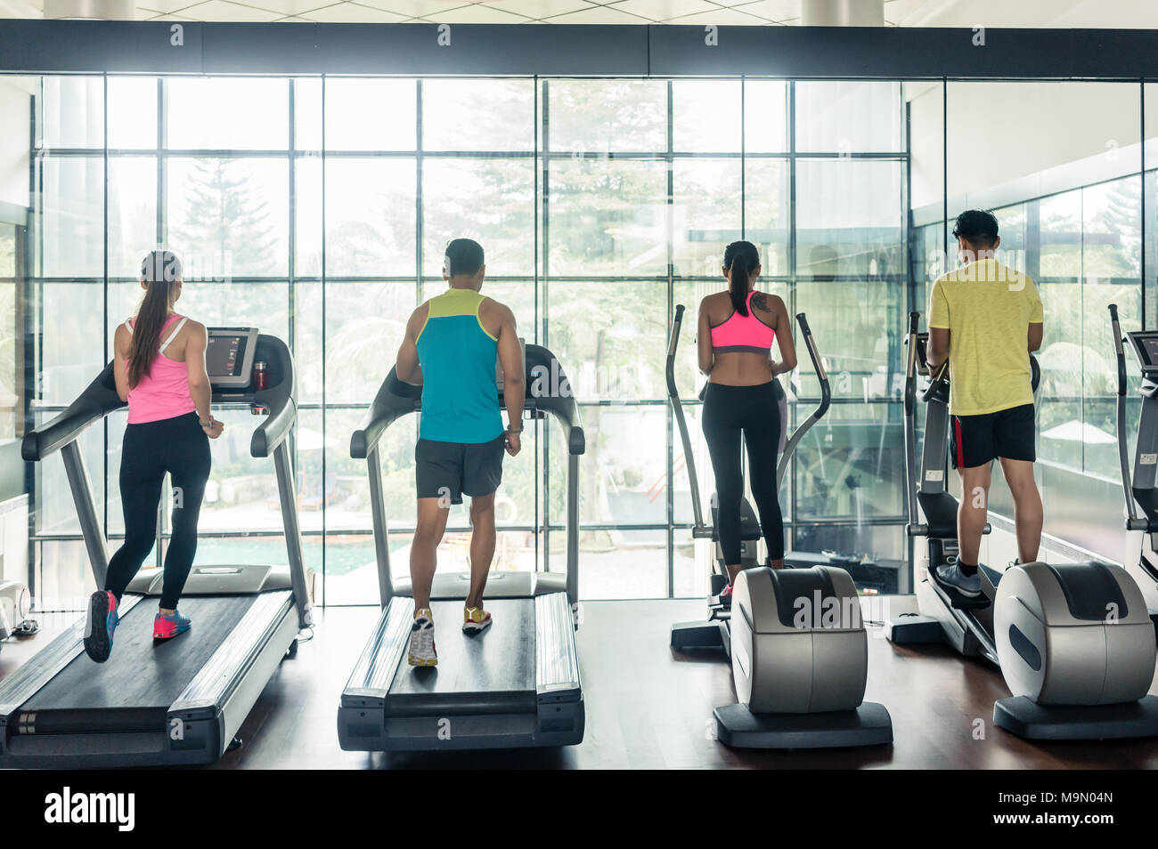Fit active woman running on treadmill Stock Photo - Alamy