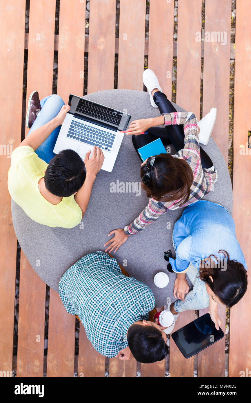 Young employees using modern wireless technology while working Stock ...