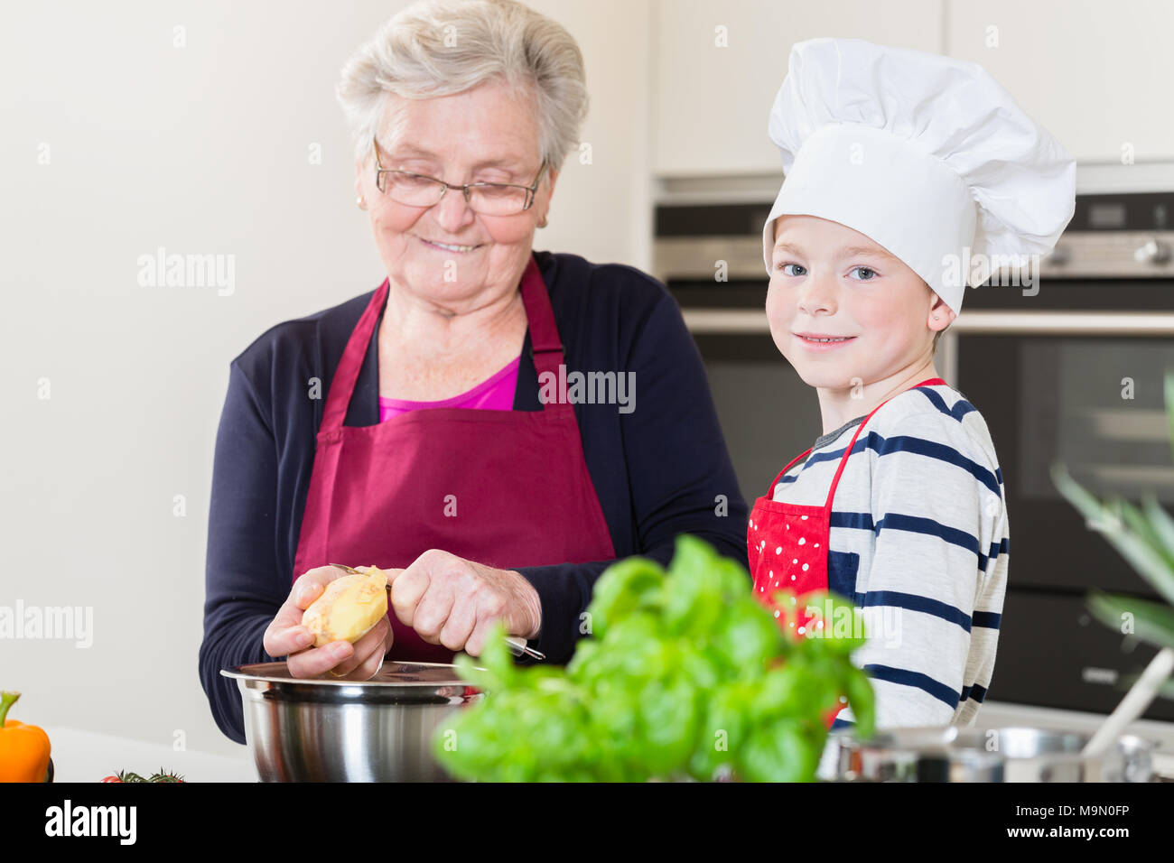 Grandma and grandson cooking together Stock Photo - Alamy
