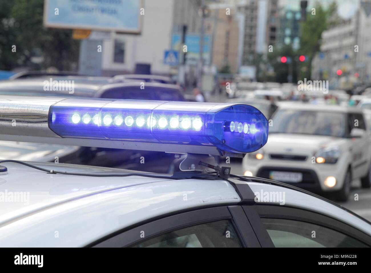 Police car with lights turned on. City lights on the background. With ...