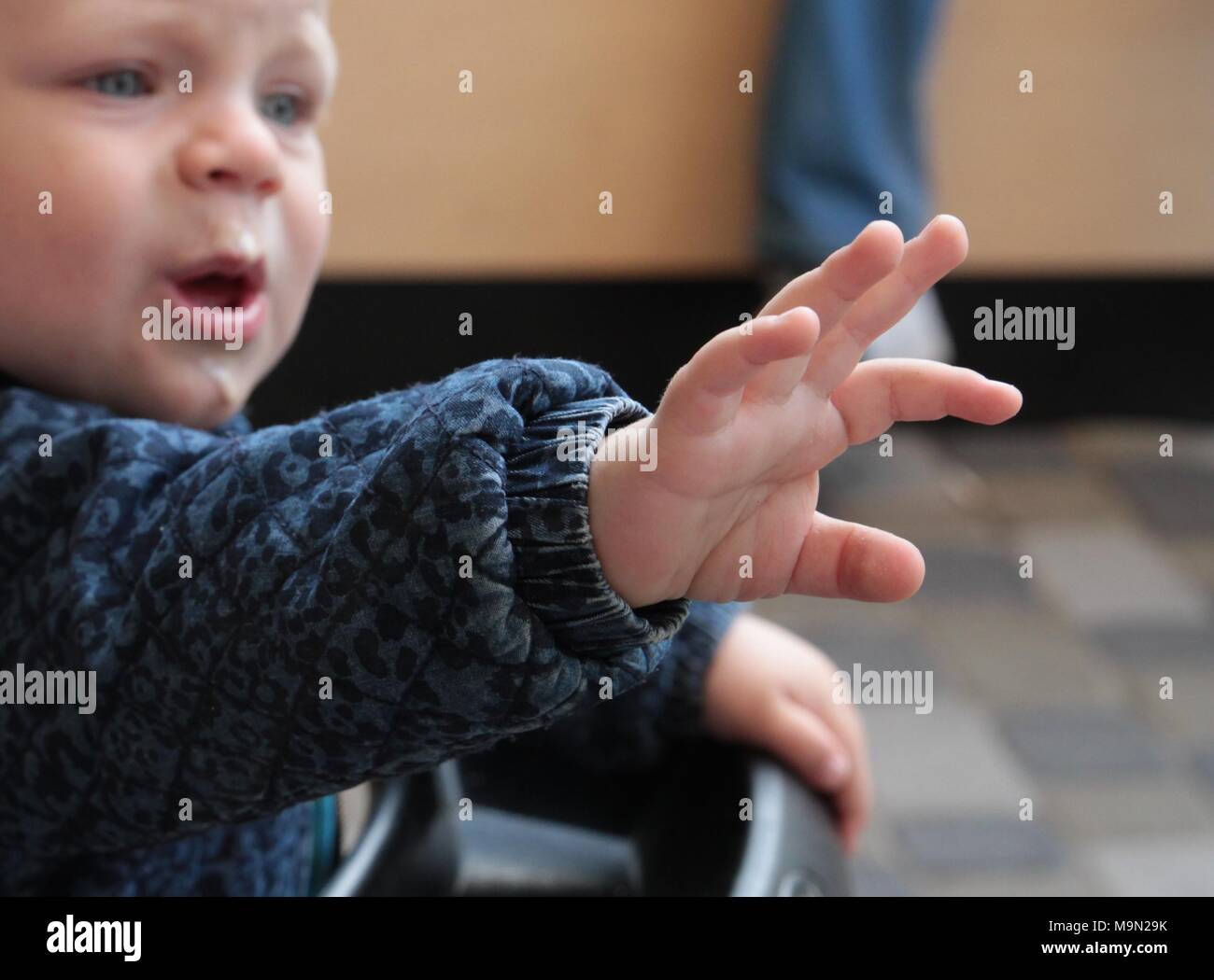 The child makes a gesture with his hand no Stock Photo - Alamy