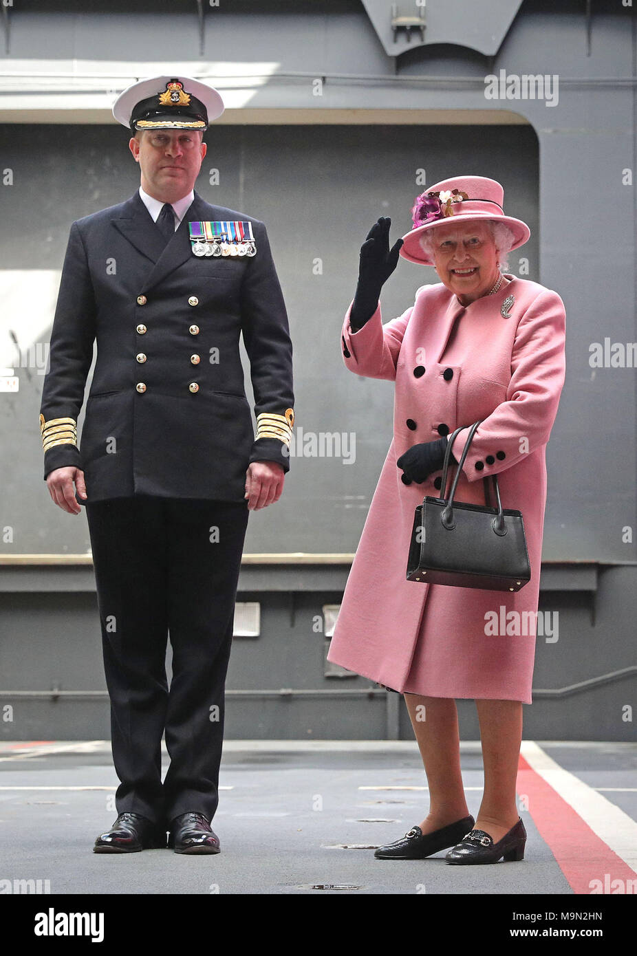 Queen Elizabeth II waves to the ships company as she leaves with the ...
