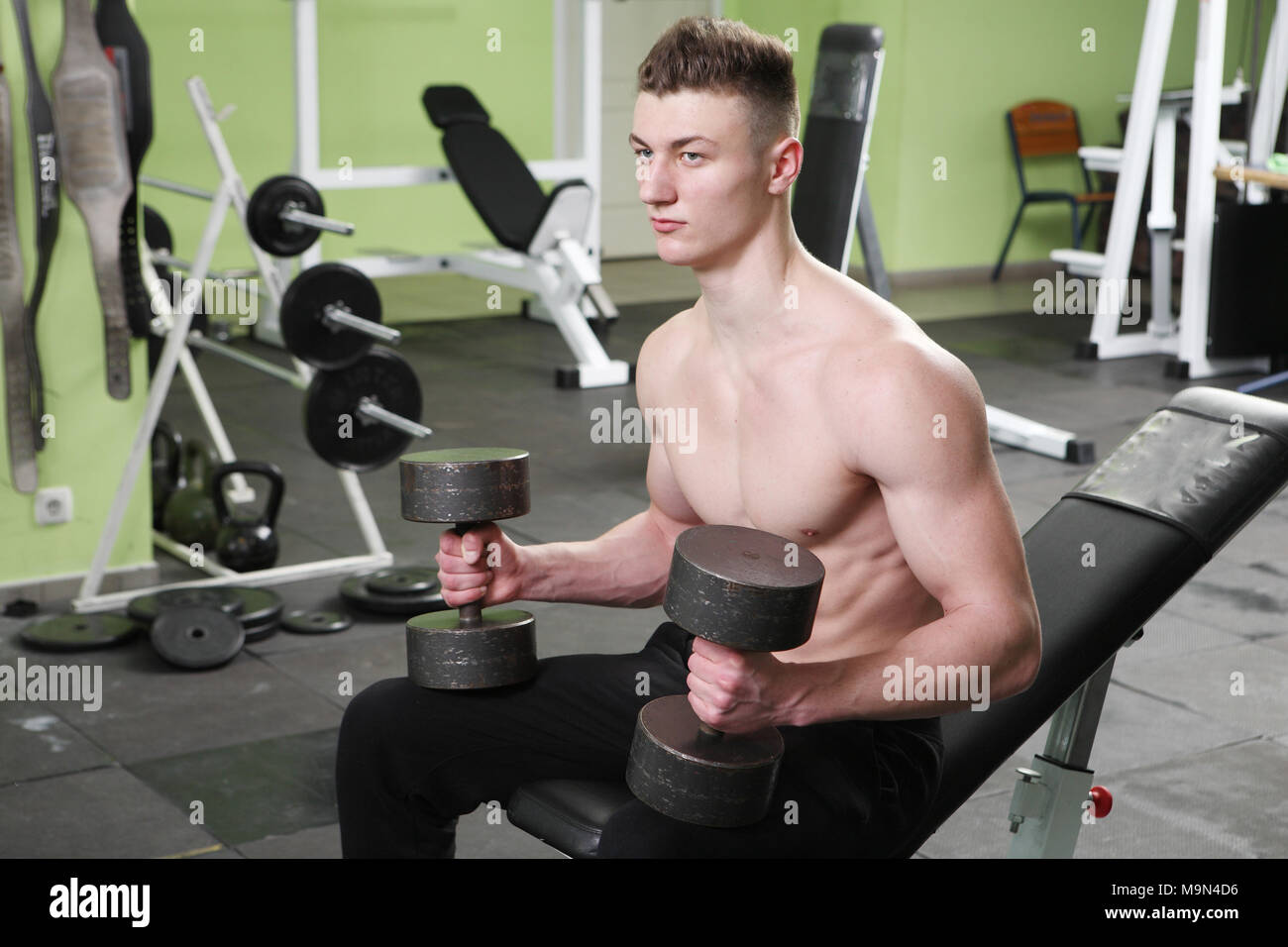 The young man is training in the gym Stock Photo - Alamy