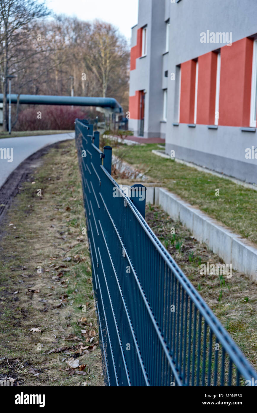 Metal fence to demarcate a plot Stock Photo - Alamy