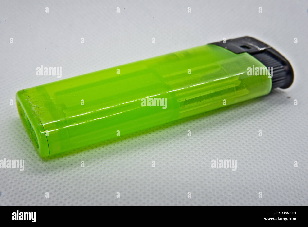 Green lighter on white background Stock Photo - Alamy
