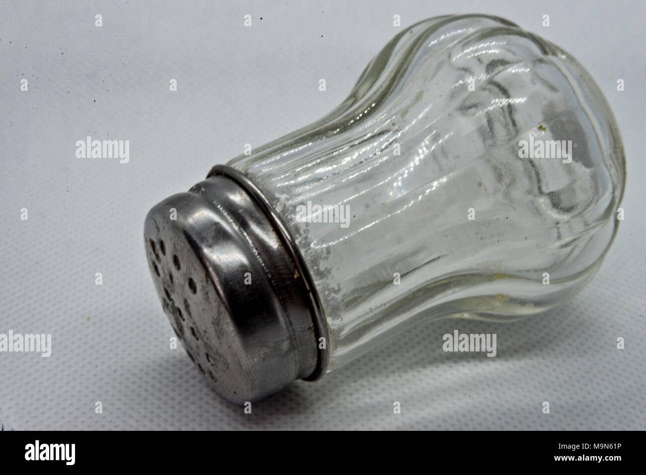 Salt shaker on white background Stock Photo - Alamy