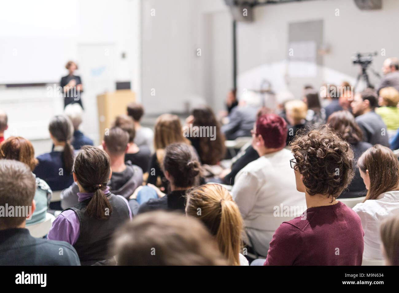 Woman giving presentation in lecture hall at university Stock Photo - Alamy