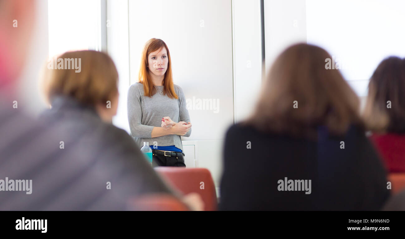 Woman giving presentation in lecture hall at university Stock Photo - Alamy