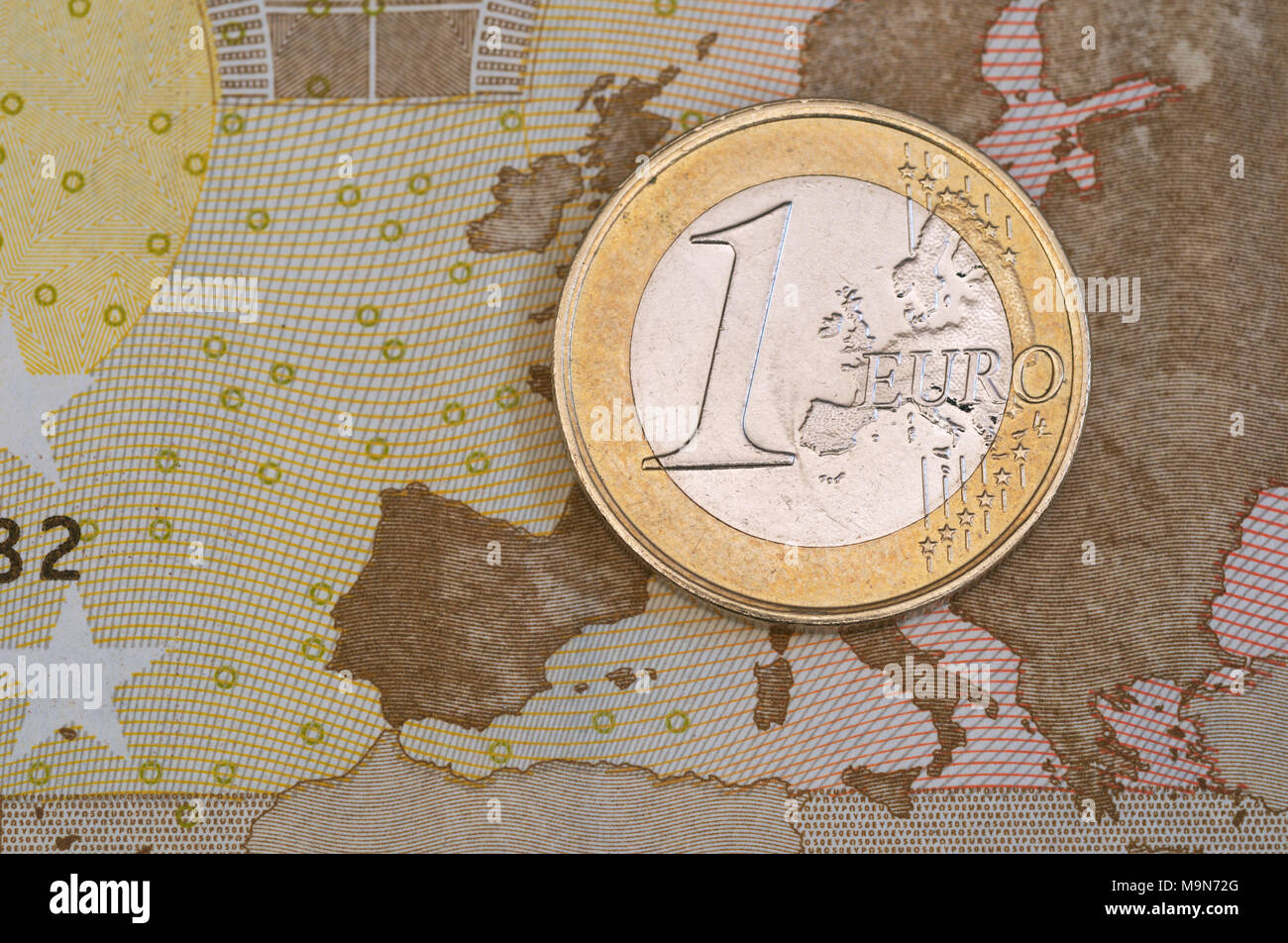 1euro coin over a banknote map Stock Photo - Alamy