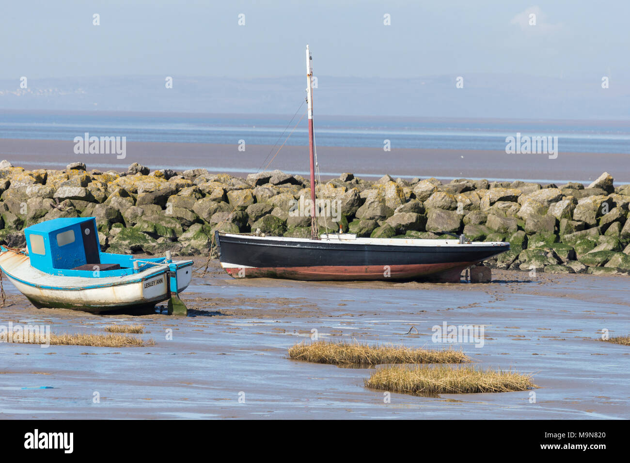 Two small inshore fishing boats aground and waiting for the tide at ...
