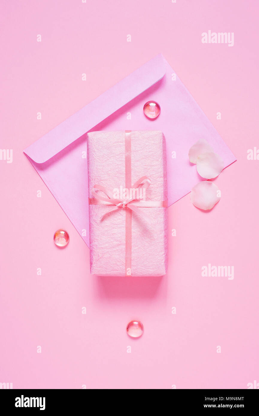 Pink gift box with bow and envelope, trendy composition Stock Photo - Alamy